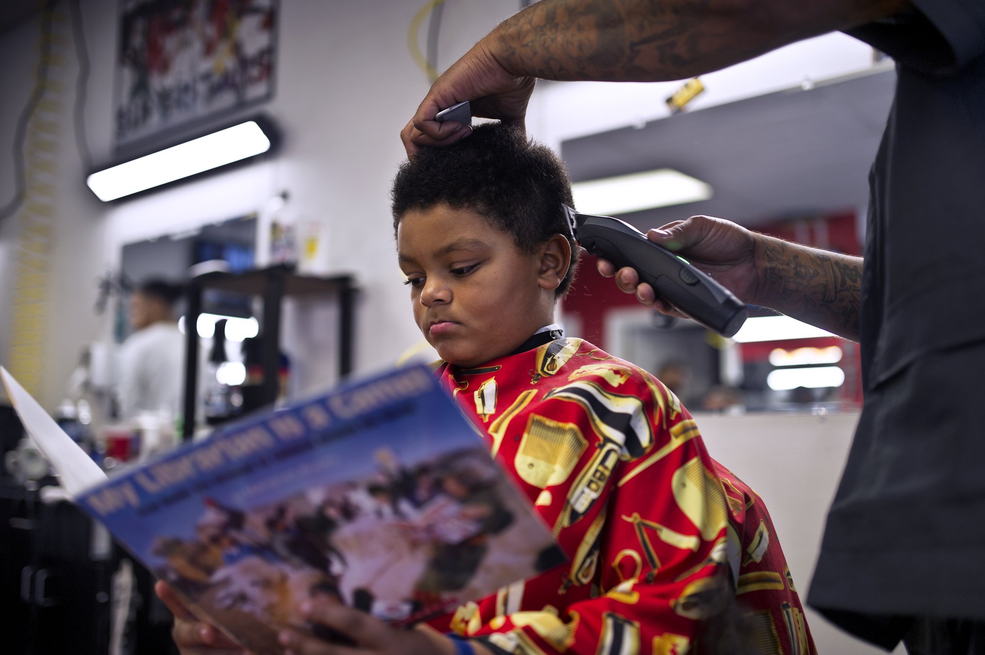 How local barber shop partners with schools to advance child literacy ...